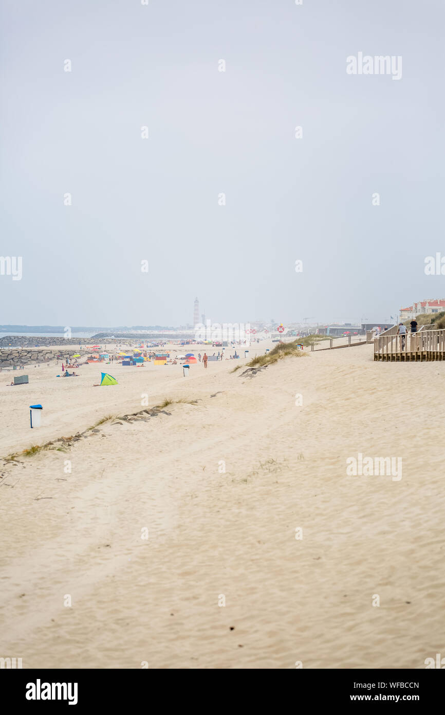 View of pedestrian wooden path on beach, people walking and people ...