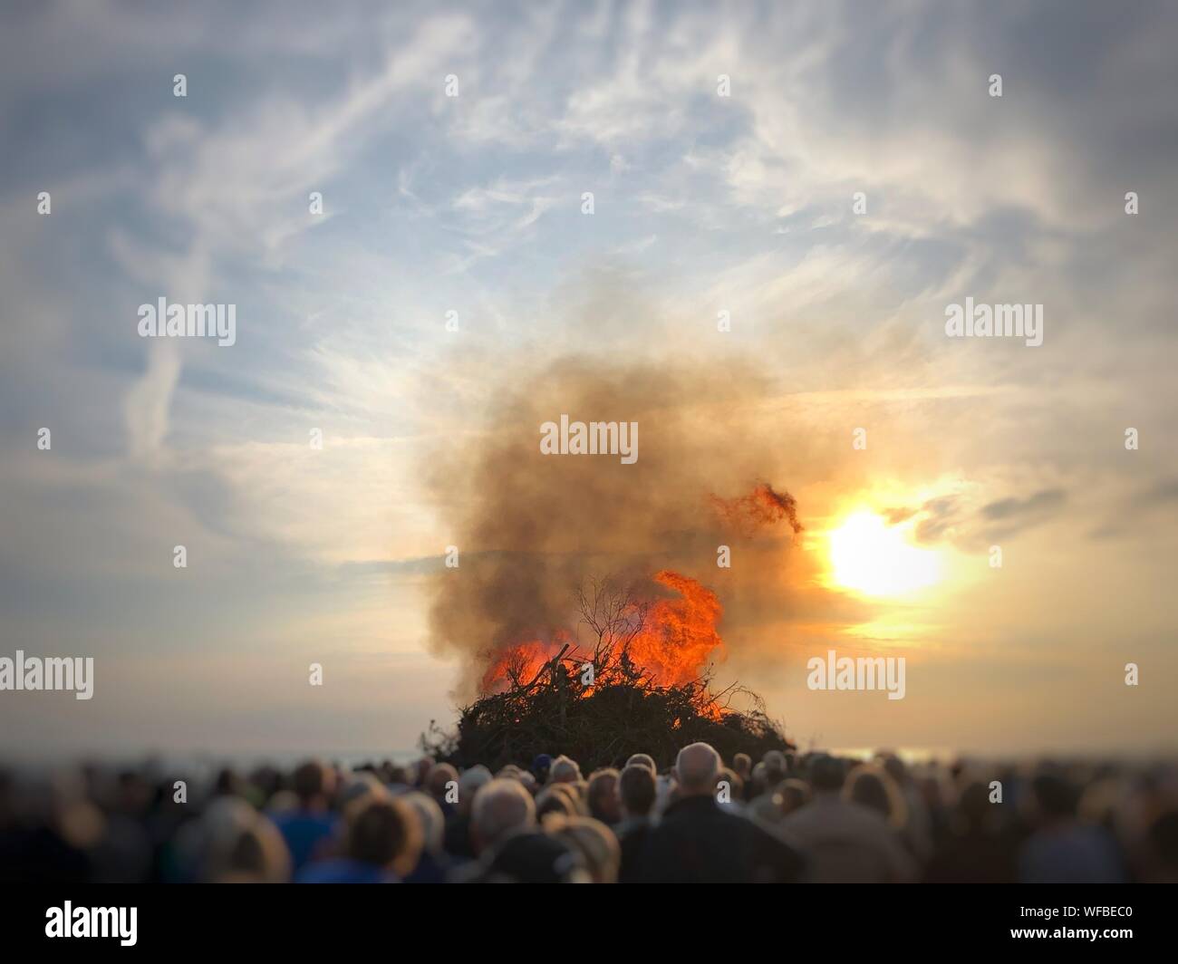 People watching a bonfire on the beach at midsummer, Fanoe, Denmark ...