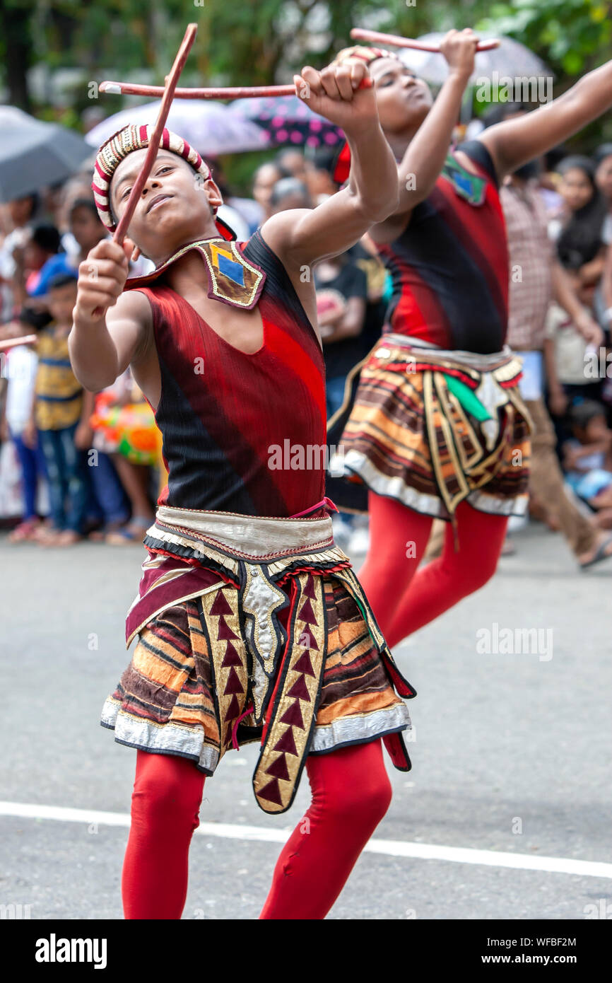 A Wood Tapper performs along a road during the Buddhist Day Perahera ...