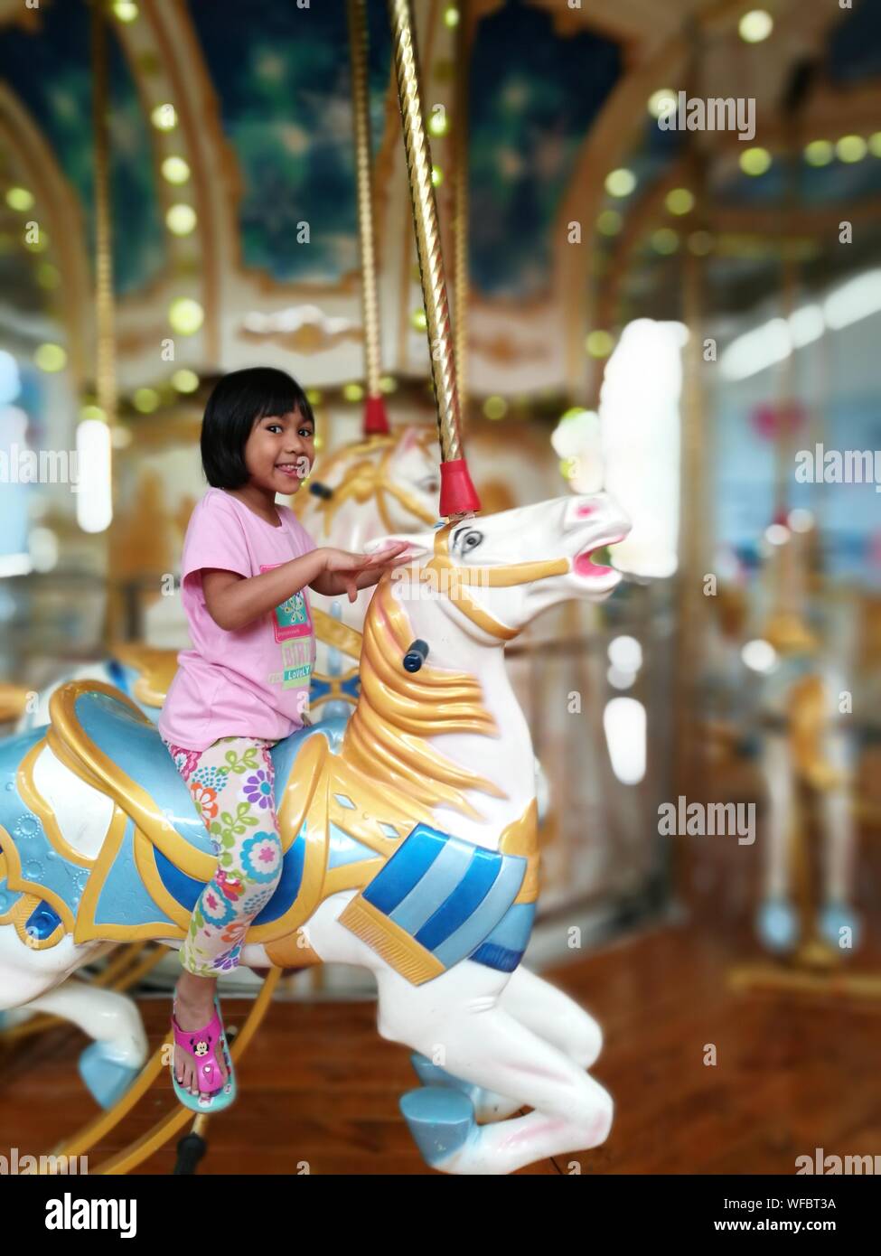 Girl sitting carousel horse hi-res stock photography and images - Alamy