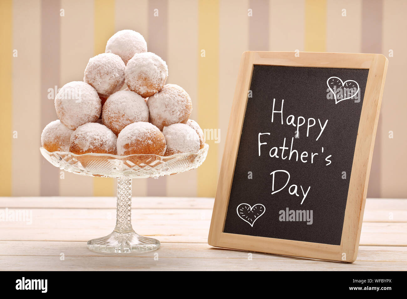 Delicious donuts and board with Happy Fathers Day inscription greetings ...