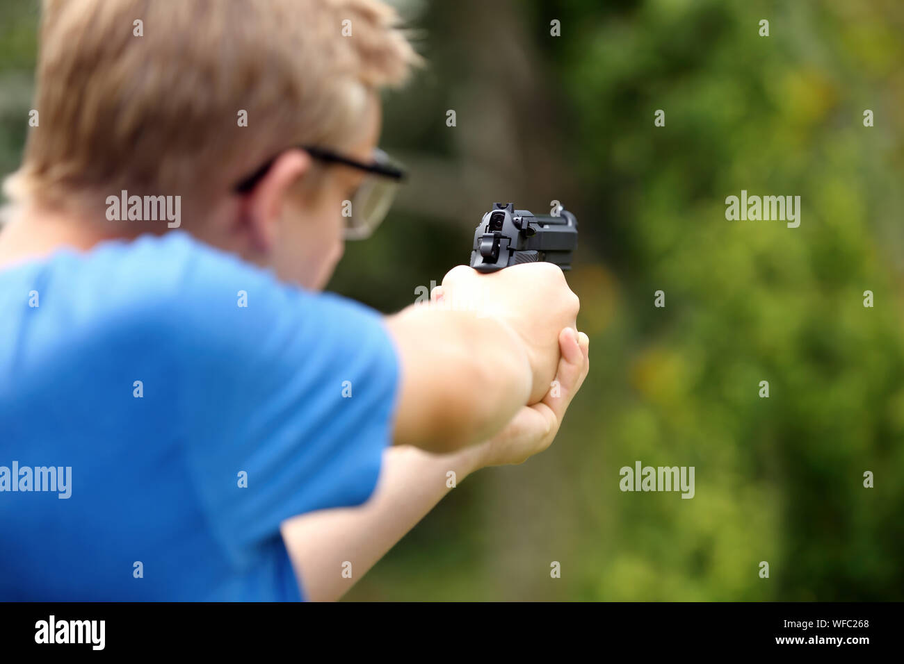 Young boy practice shooting guns on outdoor Stock Photo - Alamy
