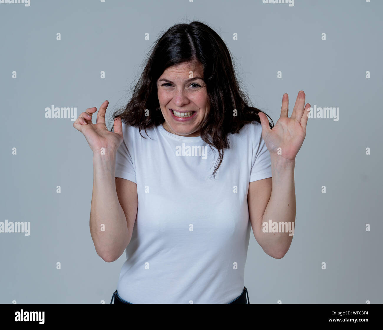 Young woman feeling scared and shocked making fear, anxiety gestures ...