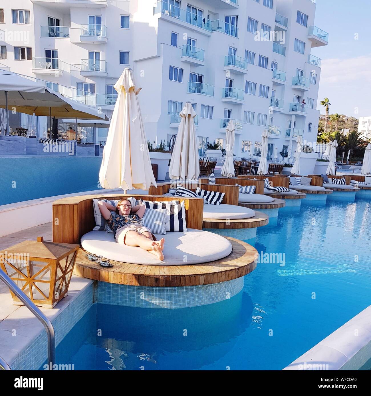 Woman relaxing by pool hi-res stock photography and images - Alamy