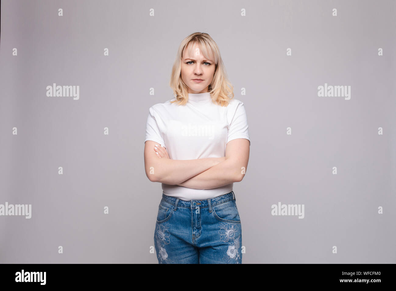 Angry or sad girl with folded arms Stock Photo - Alamy