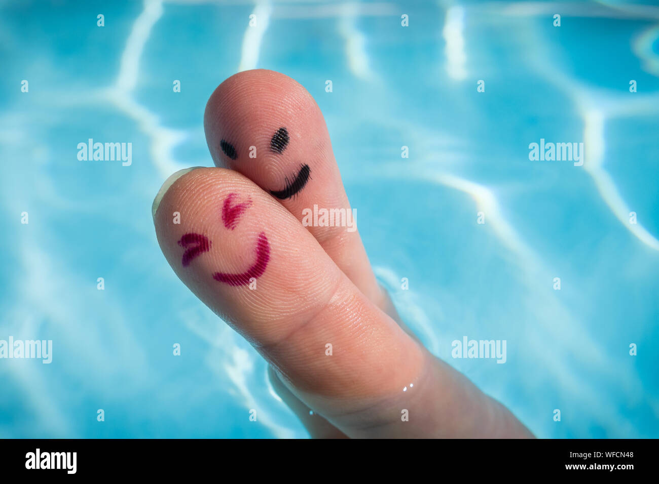 Happy finger couple for a hug in the swimming pool Stock Photo - Alamy
