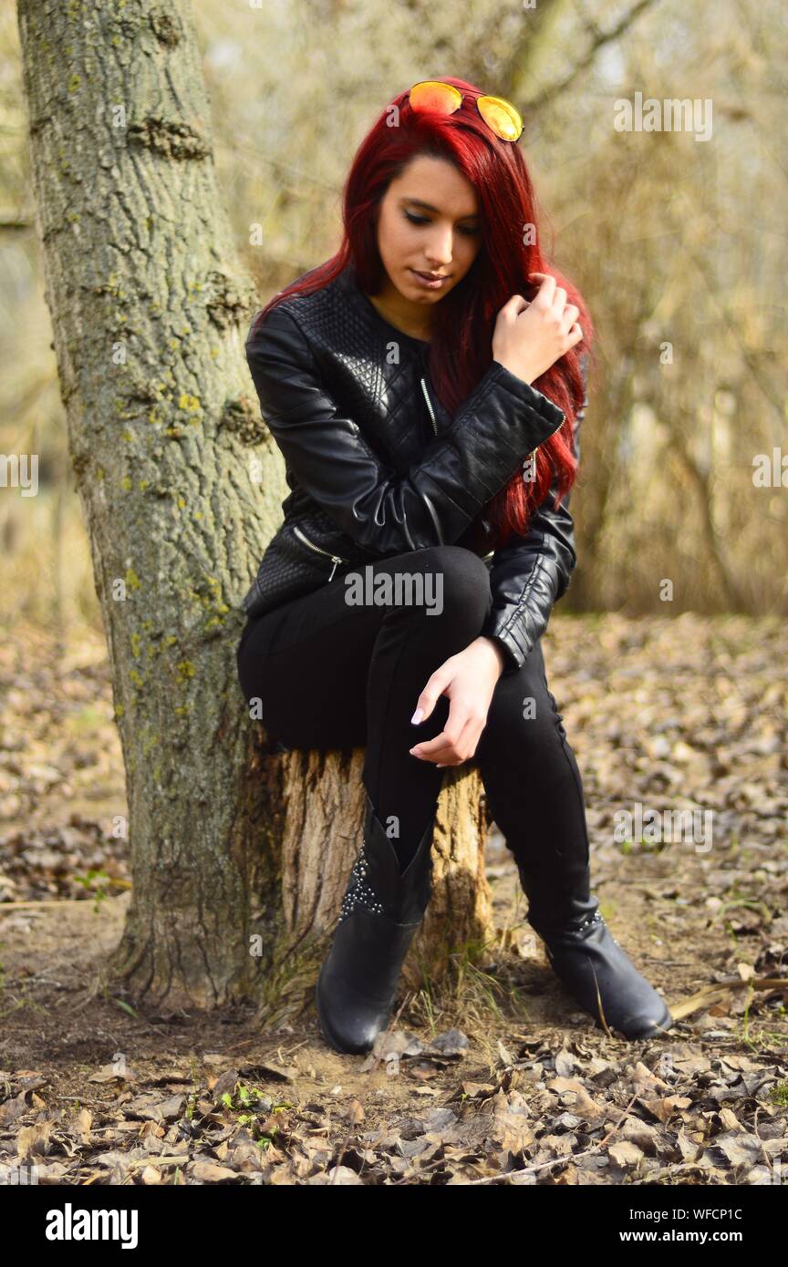 Woman Sitting Against Tree Trunk High Resolution Stock Photography and ...