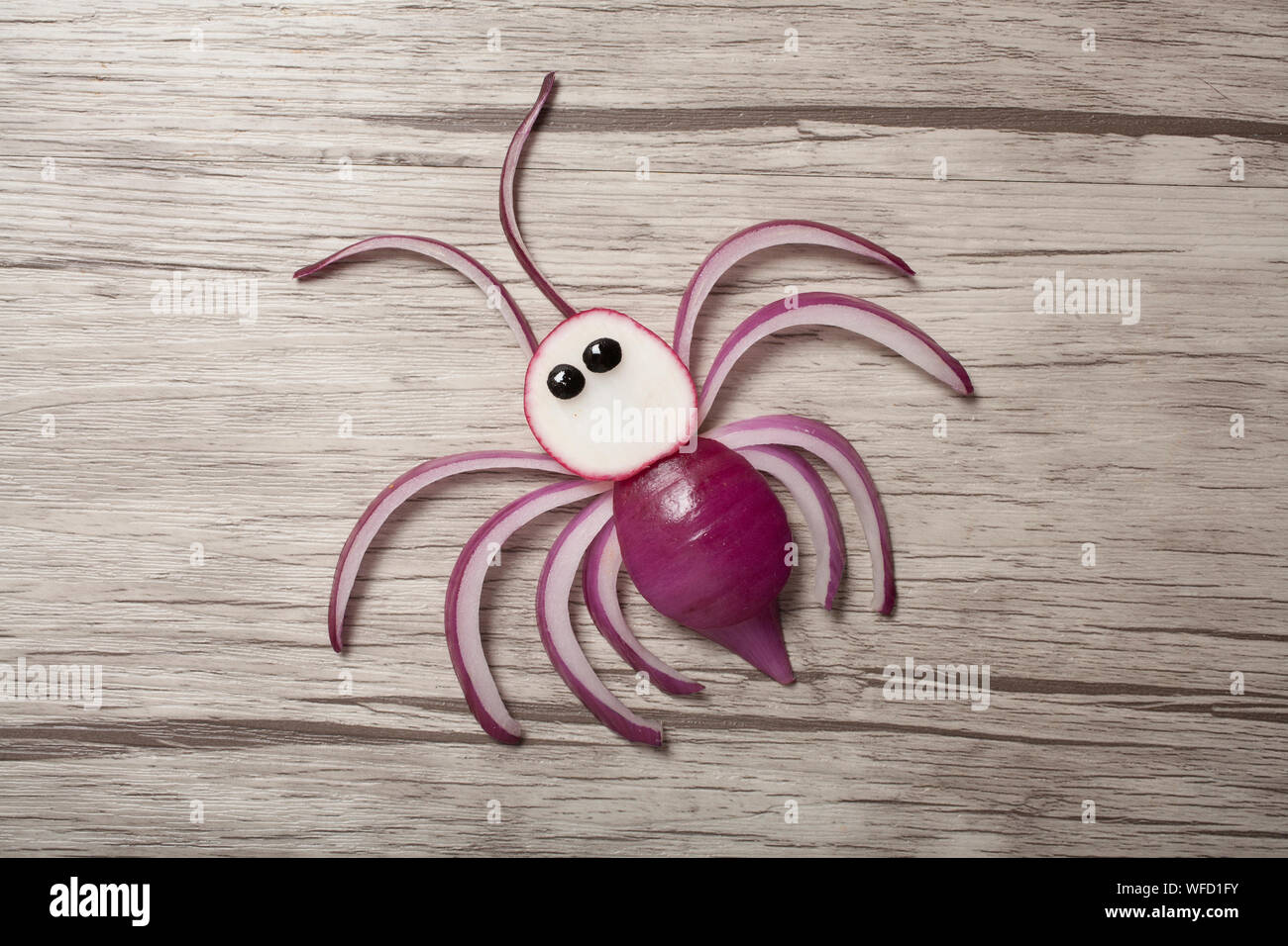 Creative receipt for making a spider with red onion Stock Photo - Alamy