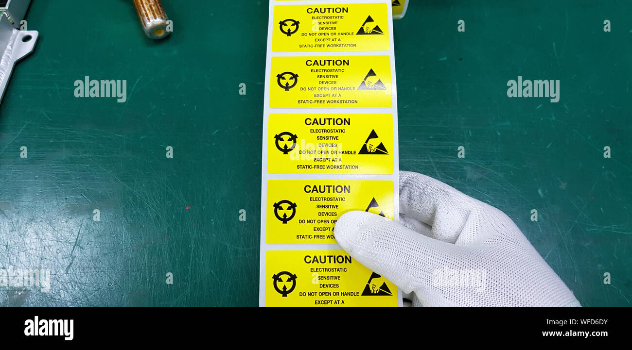 Hand holding ESD symbol label with antistatic gloves,Electrostatic ...