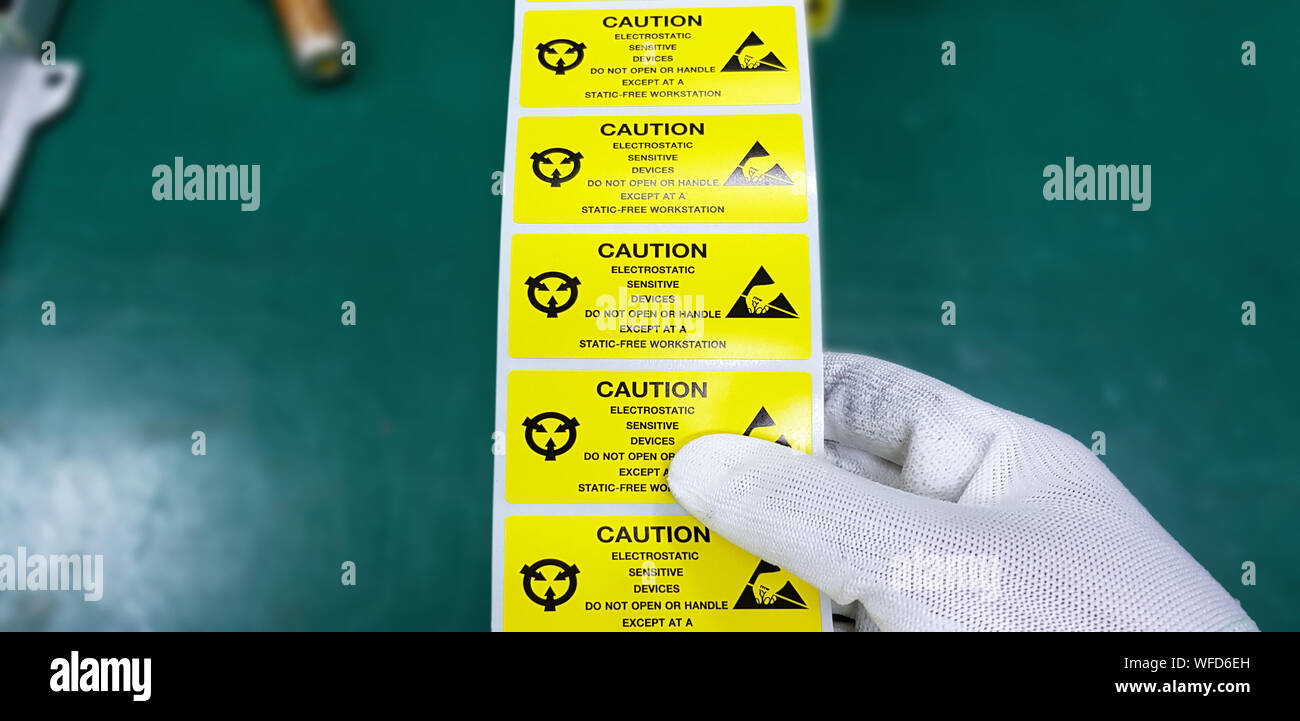 Hand holding ESD symbol label with antistatic gloves,Electrostatic ...