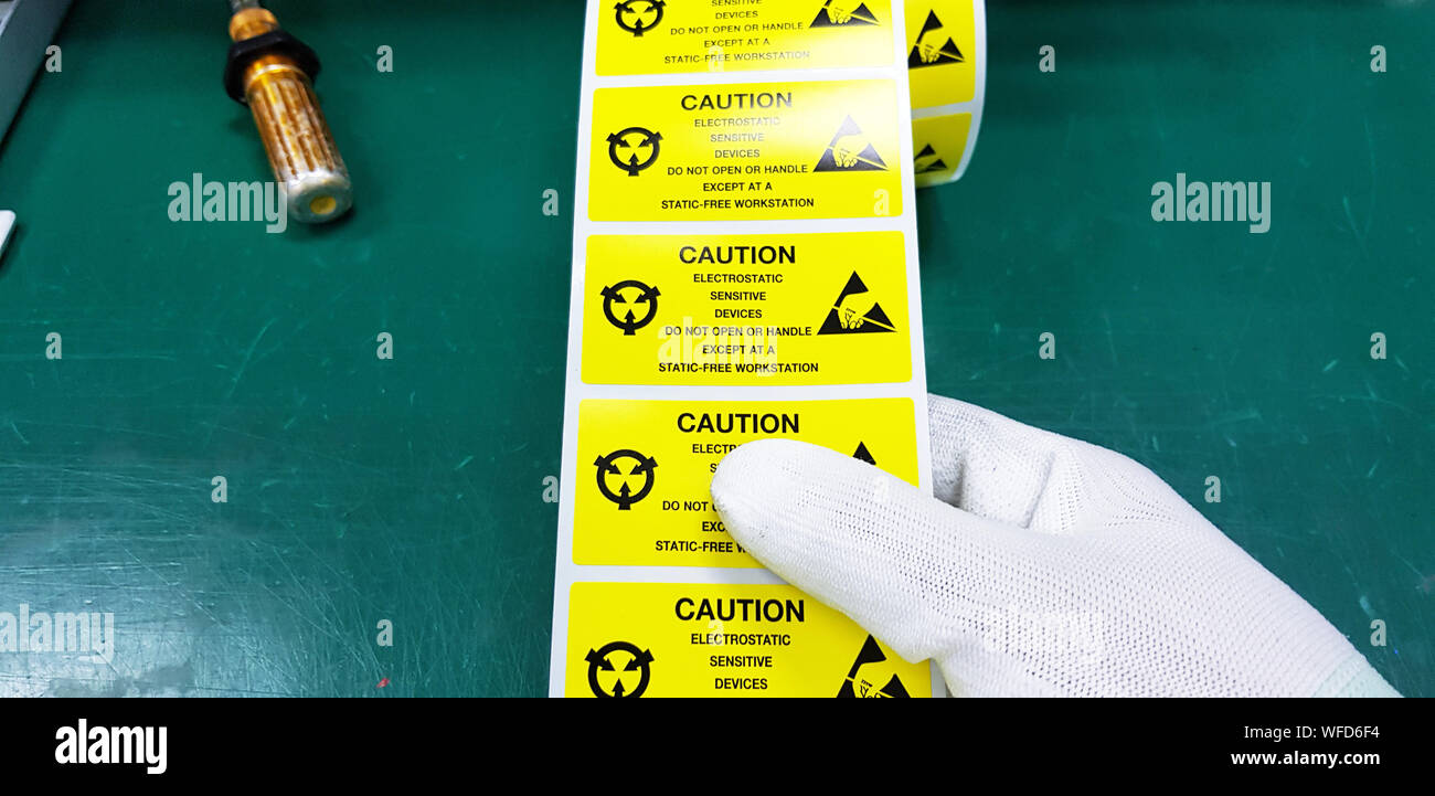 Hand holding ESD symbol label with antistatic gloves,Electrostatic ...