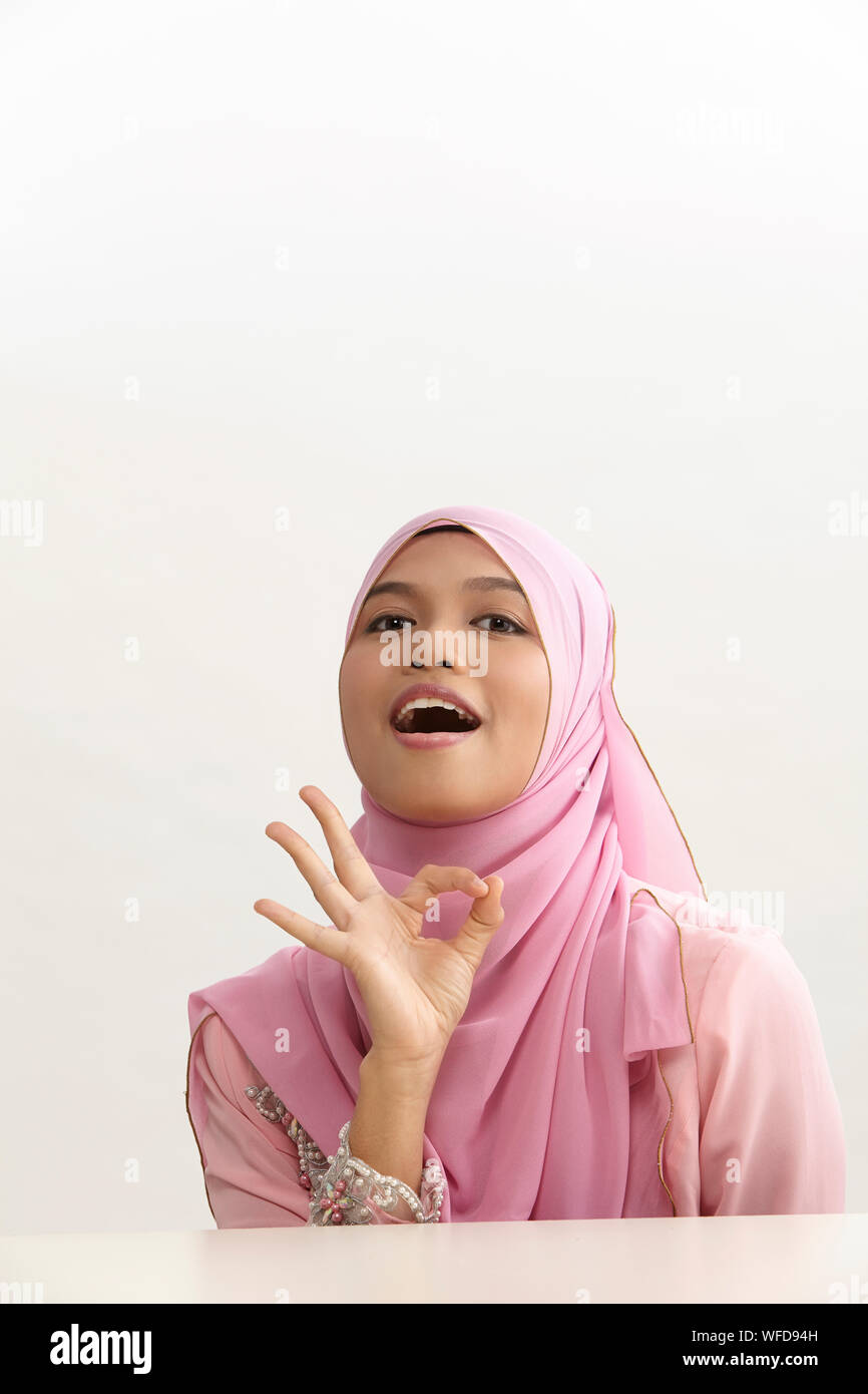 malay woman with tudung with hand sign ok Stock Photo - Alamy