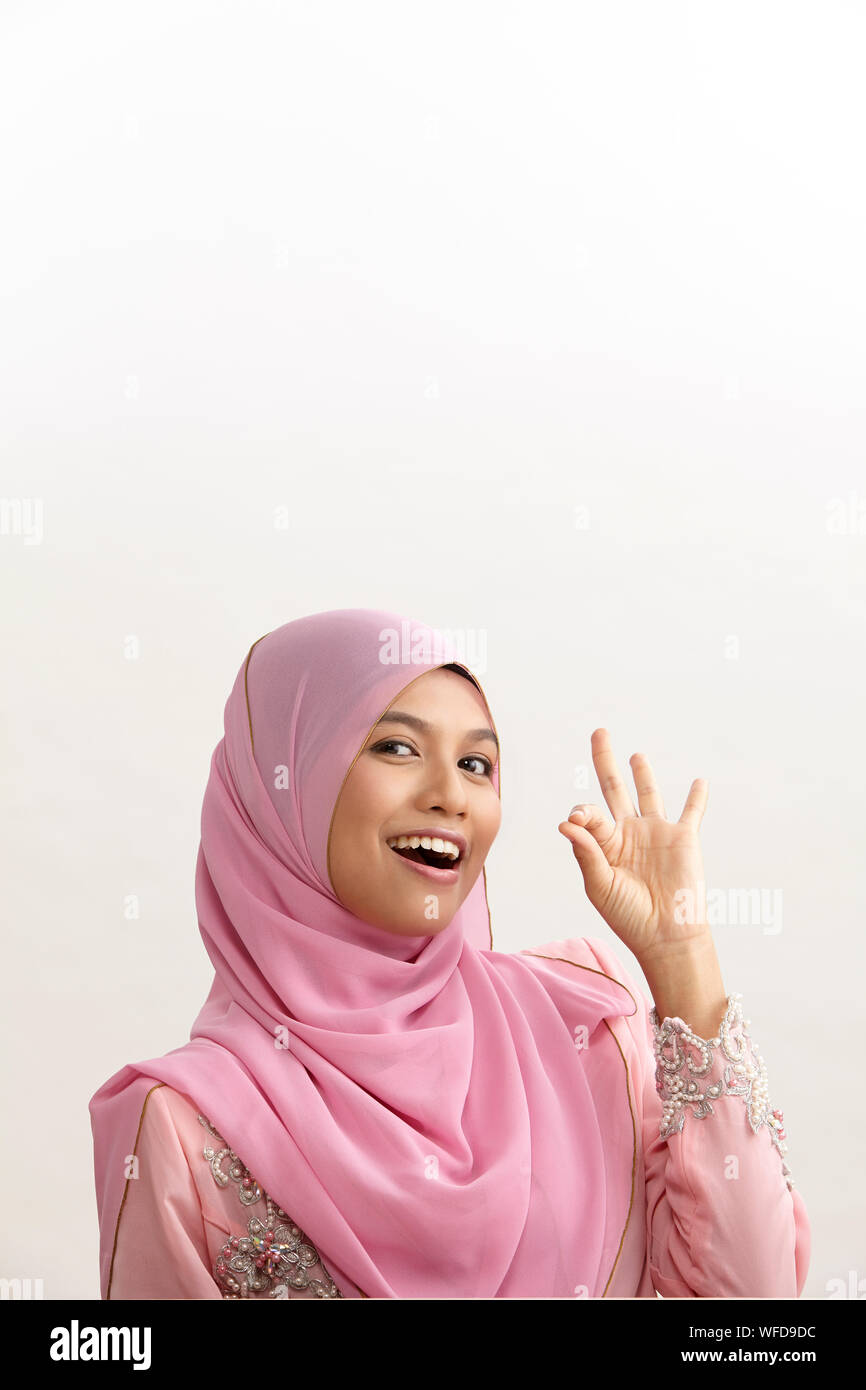 malay woman with tudung with hand sign ok Stock Photo - Alamy