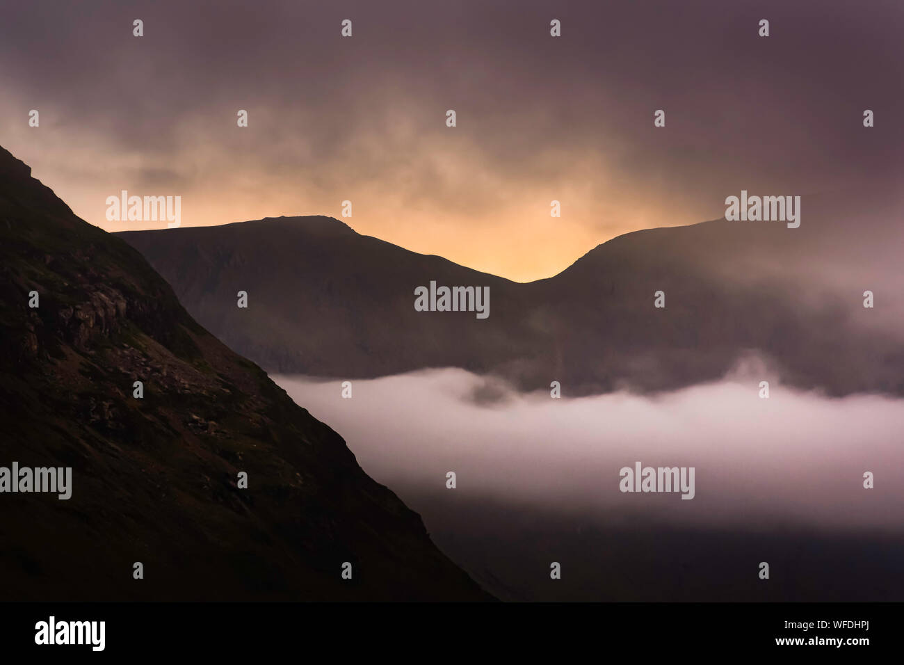 Sunrise over mountain ridge in Lake District, UK.Dark, dramatic sky ...