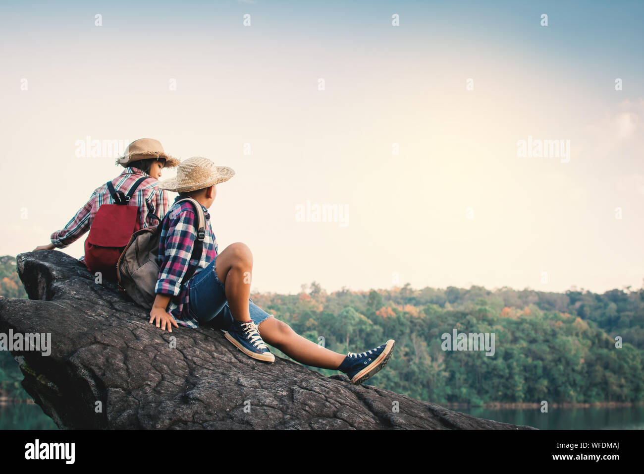 Two boys sitting on rock hi-res stock photography and images - Alamy