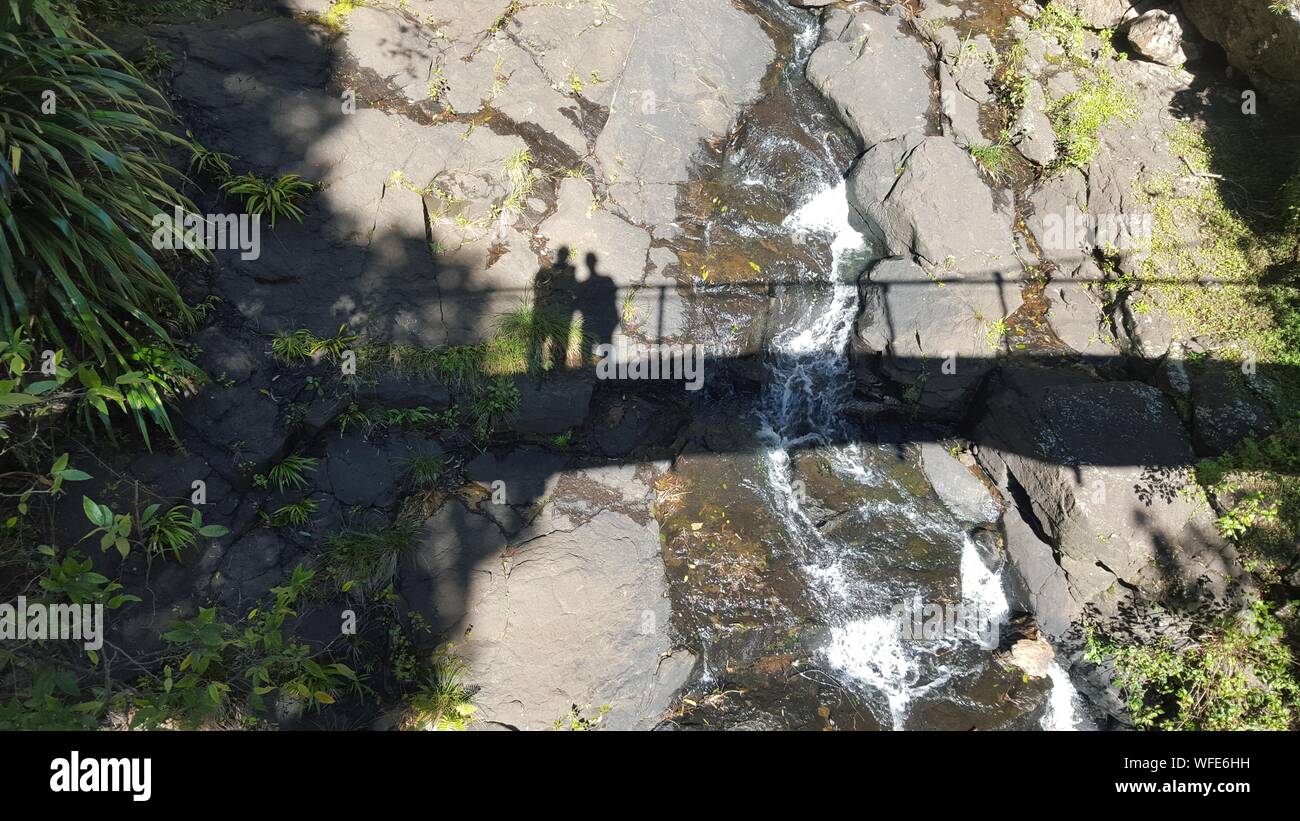 Shadow Of People Falling On Rocks With Waterfall Stock Photo - Alamy