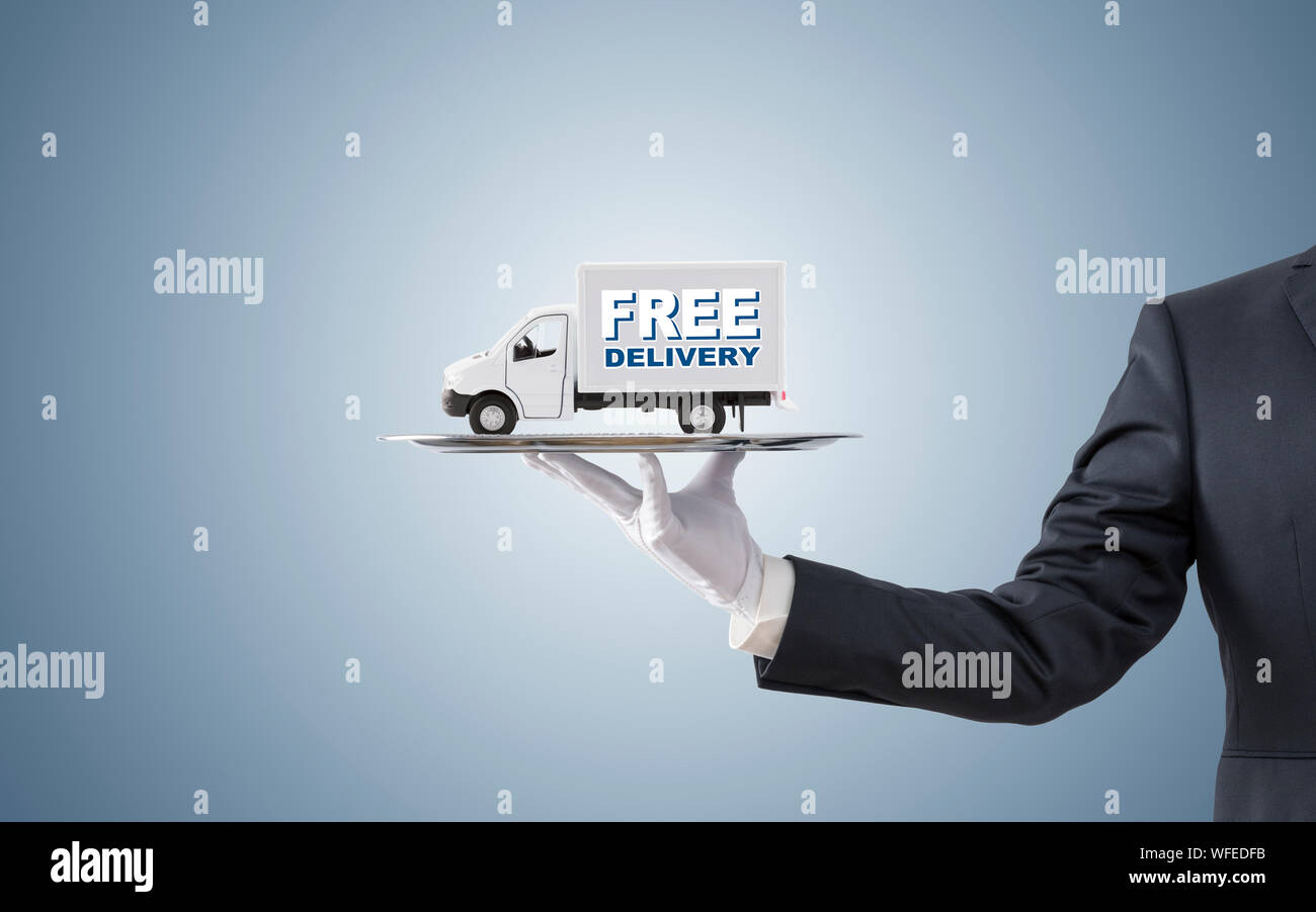 Businessman offering free delivery on silver tray Stock Photo - Alamy