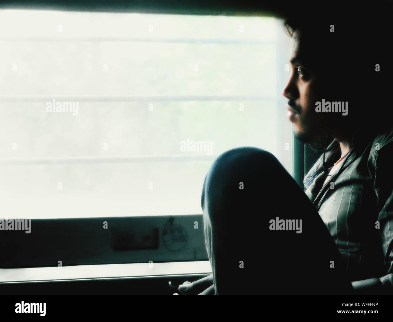 Person looking out train window hi-res stock photography and images - Alamy