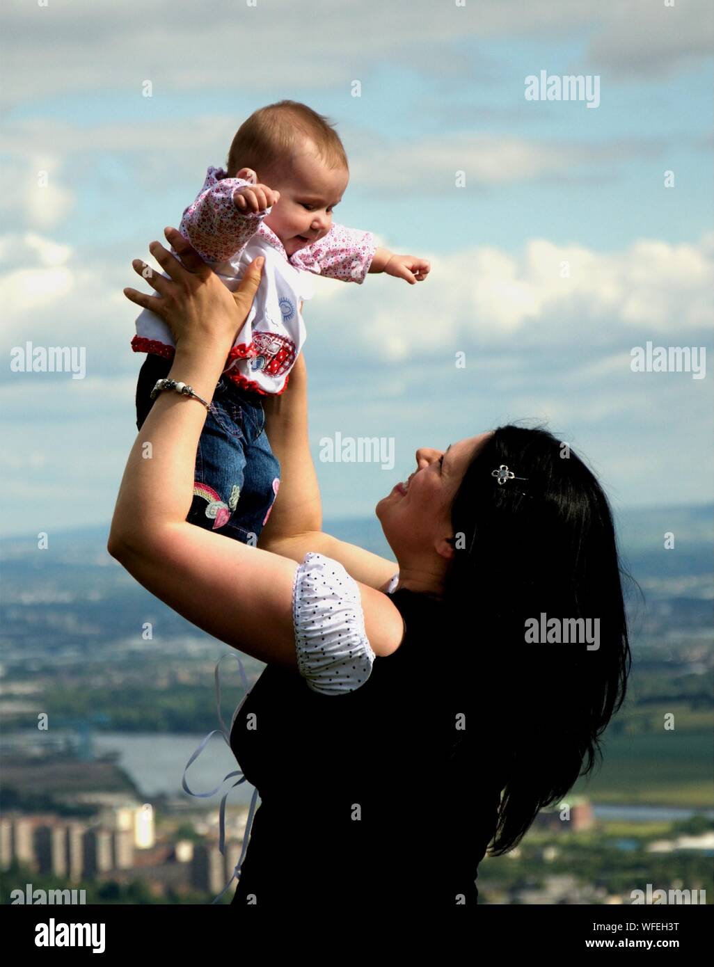 Lifting baby hi-res stock photography and images - Alamy