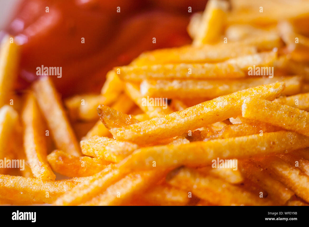 Closeup of french fries corn snacks sticks with ketchup Stock Photo - Alamy