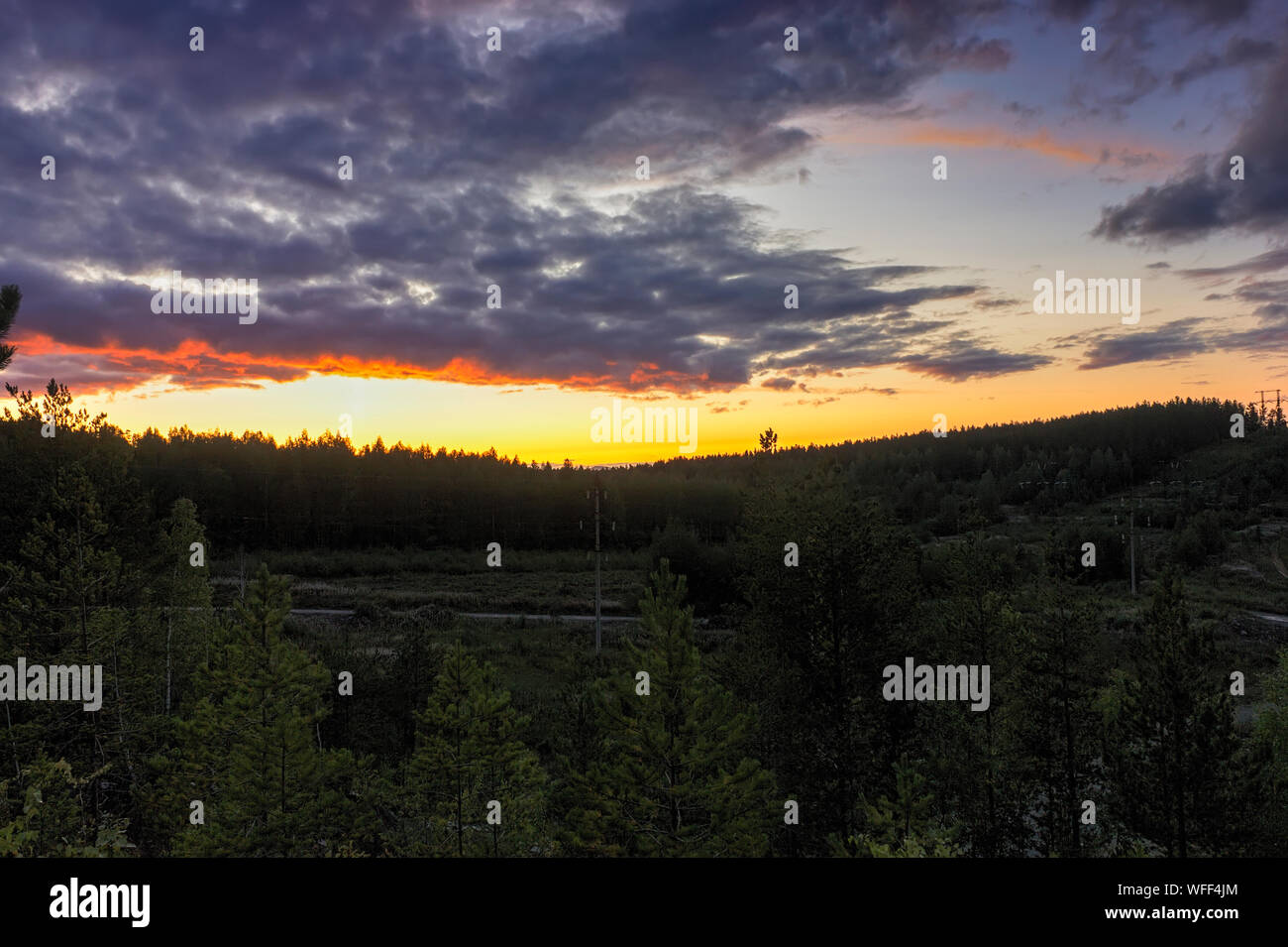 Cumulus sunset clouds with sun setting down. The sky with dark clouds ...