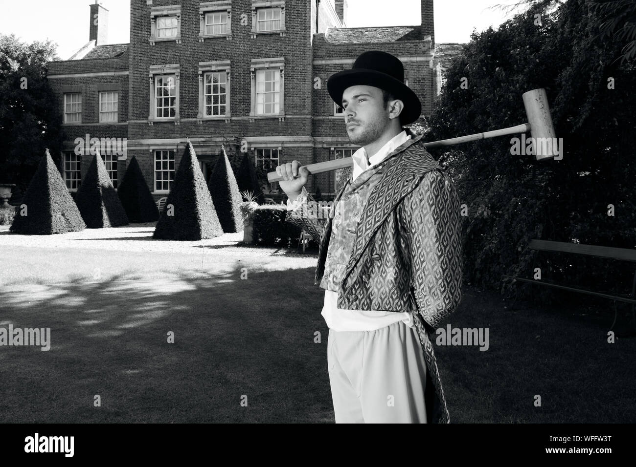 Good looking, young gentleman dressed in vintage costume standing in ...