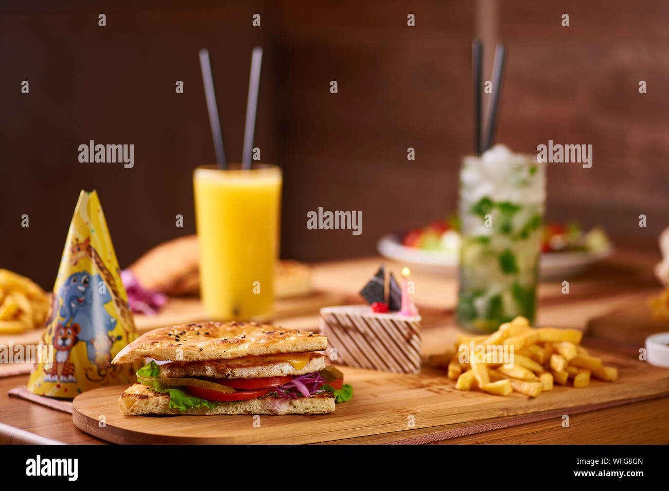 fast food served table for company of friends. burger, french fries and ...