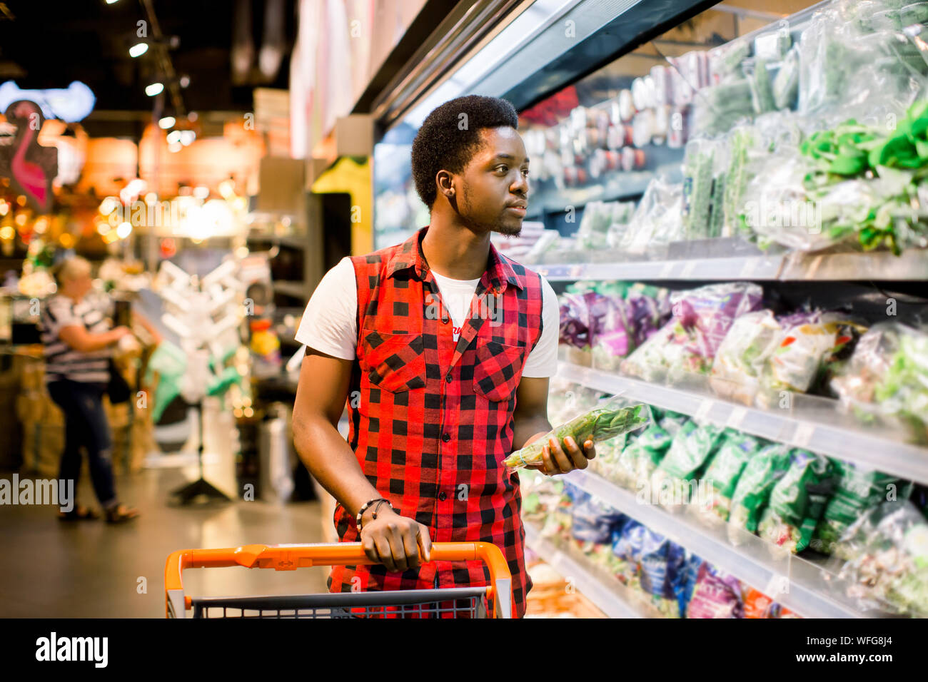 Man Pushing Trolley By Produce Counter In Supermarket Stock Photo - Alamy