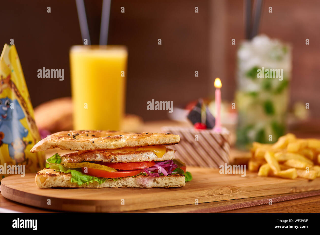 fast food served table for company of friends. burger, french fries and ...