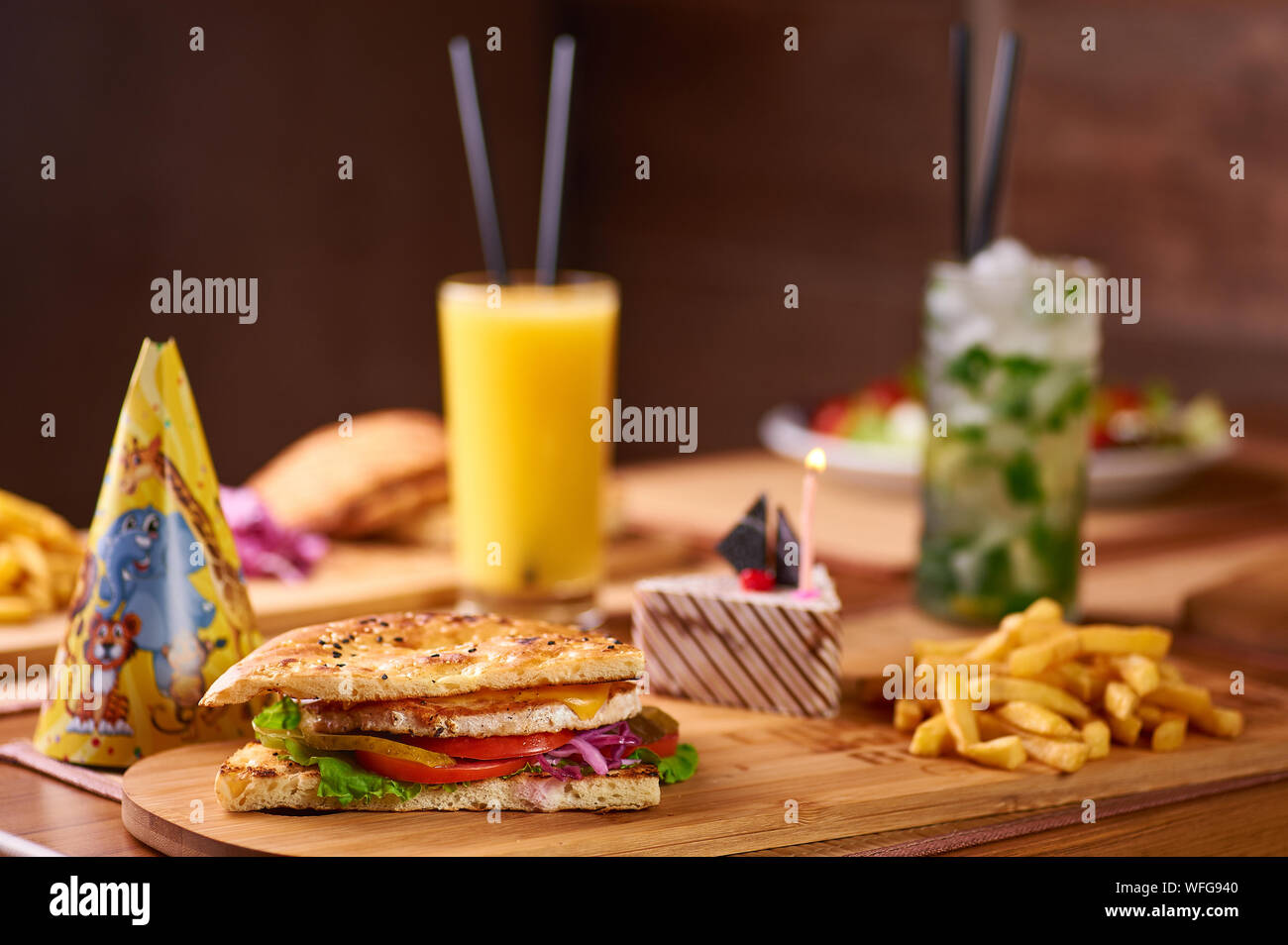 fast food served table for company of friends. burger, french fries and ...