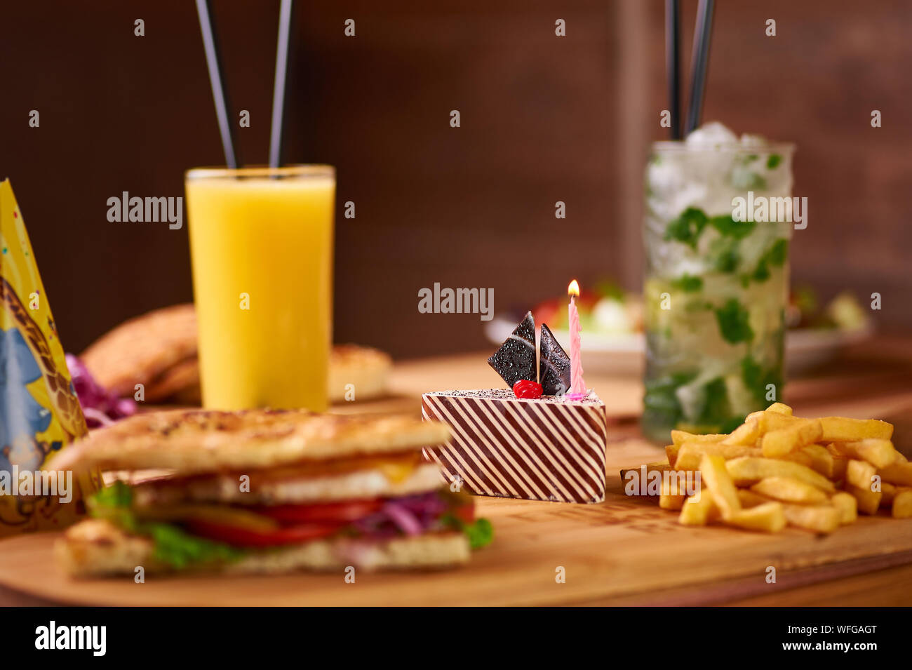 fast food served table for company of friends. burger, french fries and ...