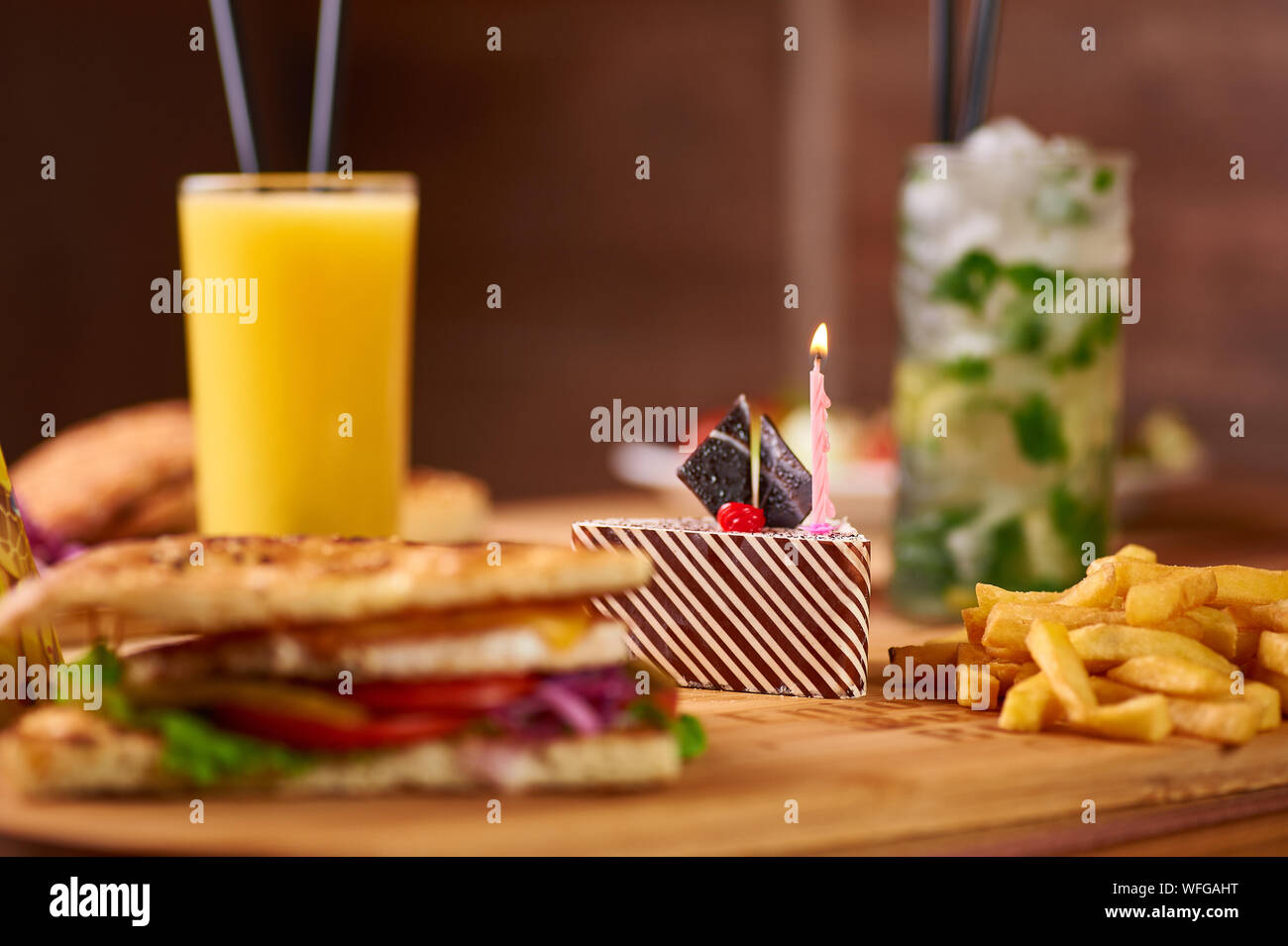 fast food served table for company of friends. burger, french fries and ...