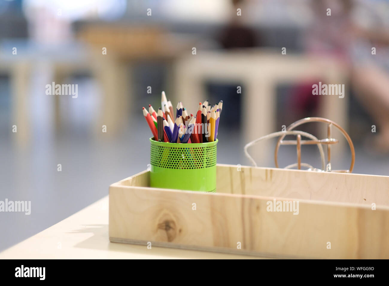 Color pencils in a glass and a wooden box for accessories in the ...