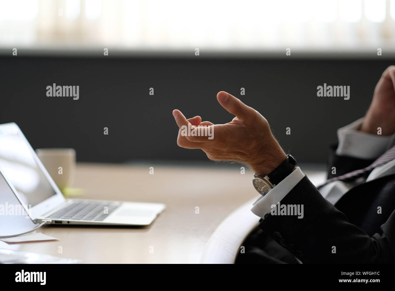 Businessman gesturing with his hands while talking on the phone in the ...
