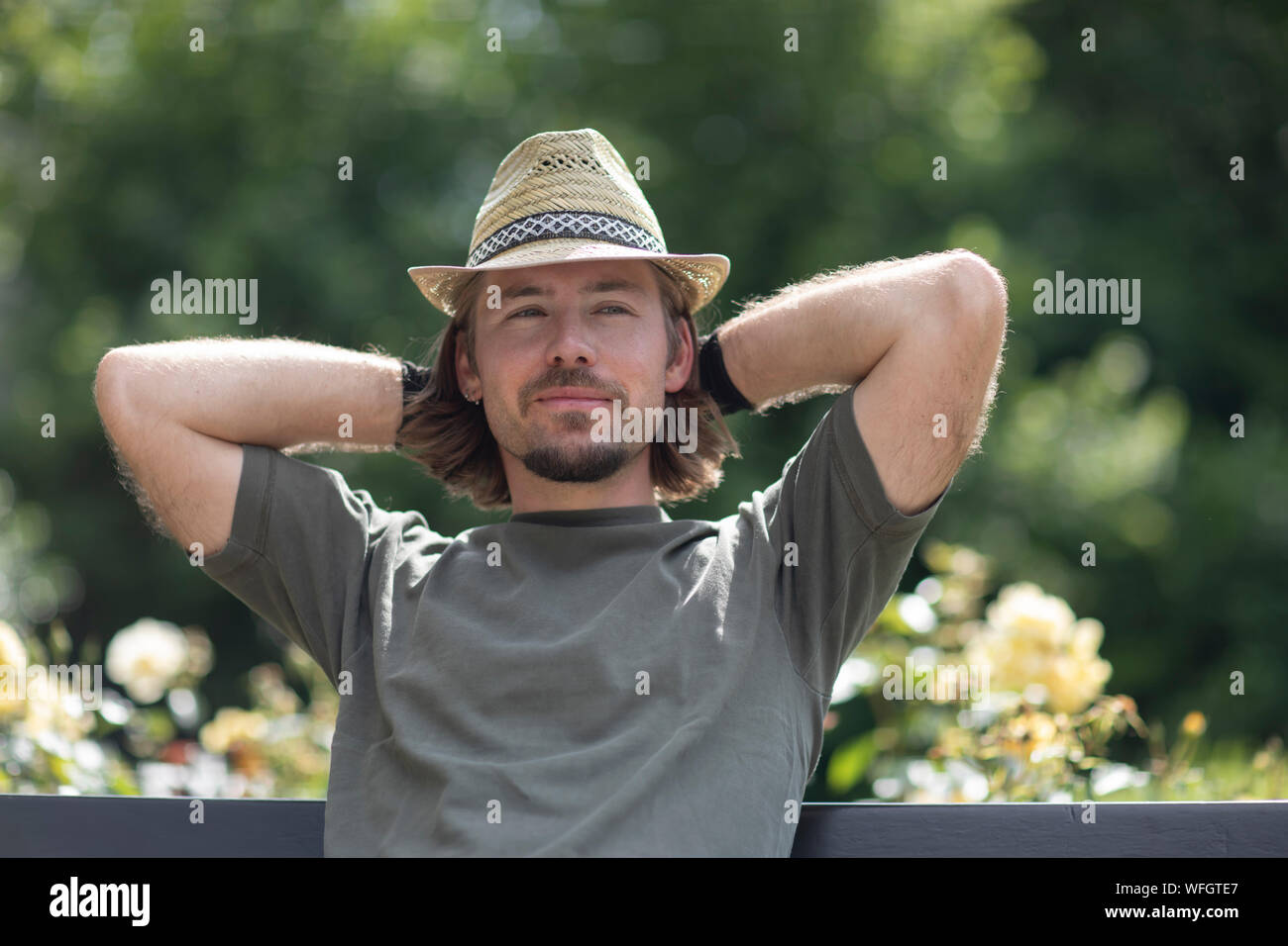 Man sitting in garden relaxing in between gardening, Germany Stock ...