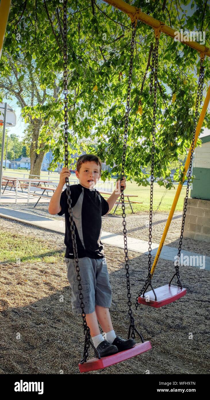 Boy standing swing hi-res stock photography and images - Alamy