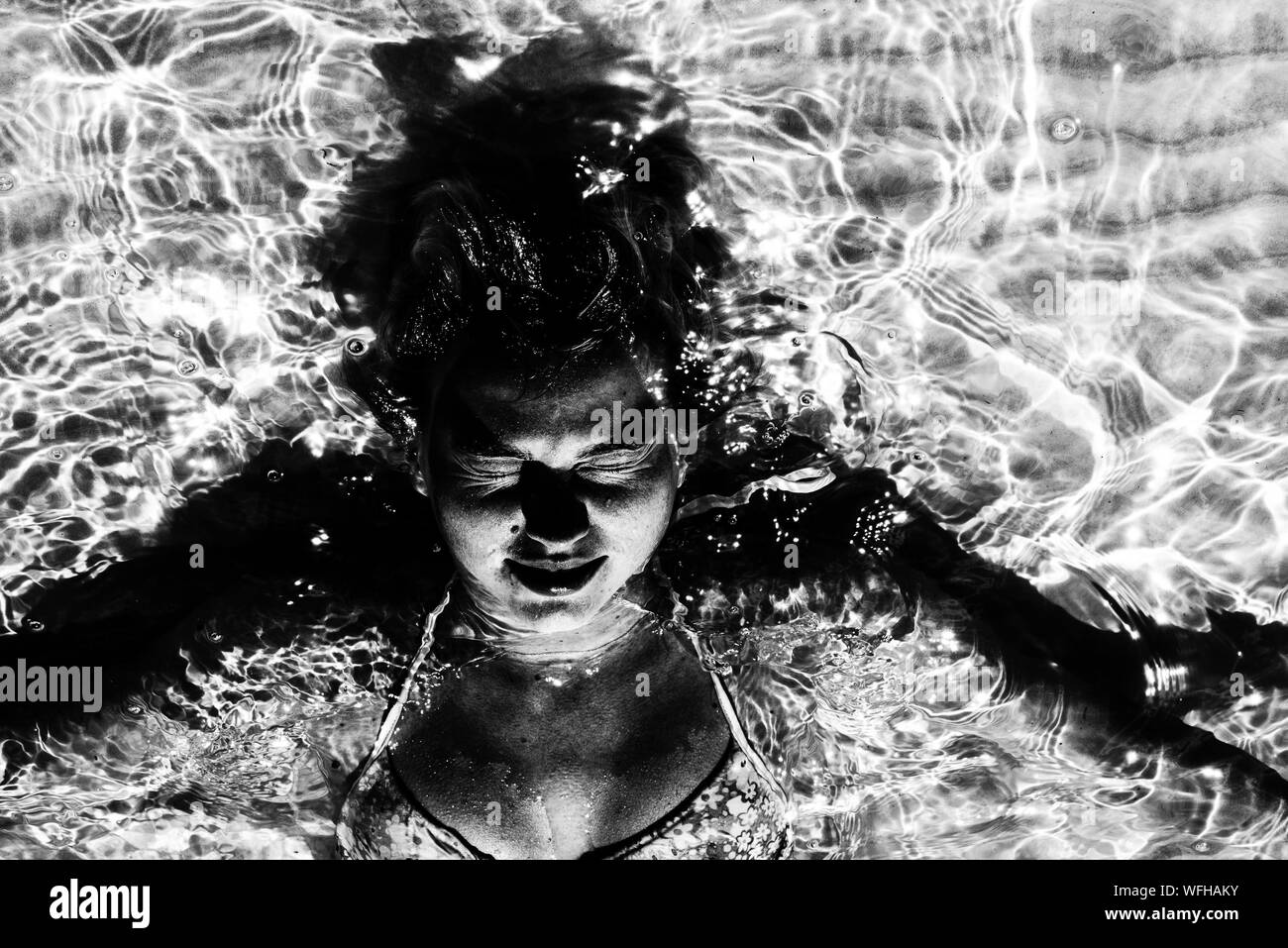 Woman Floating On Back In Water High Resolution Stock Photography and ...