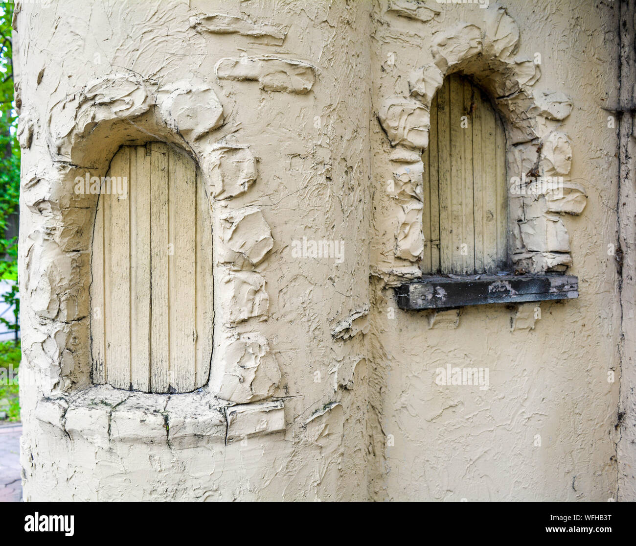 Imitation of medieval castle wall with tower shuttered window. Detail ...