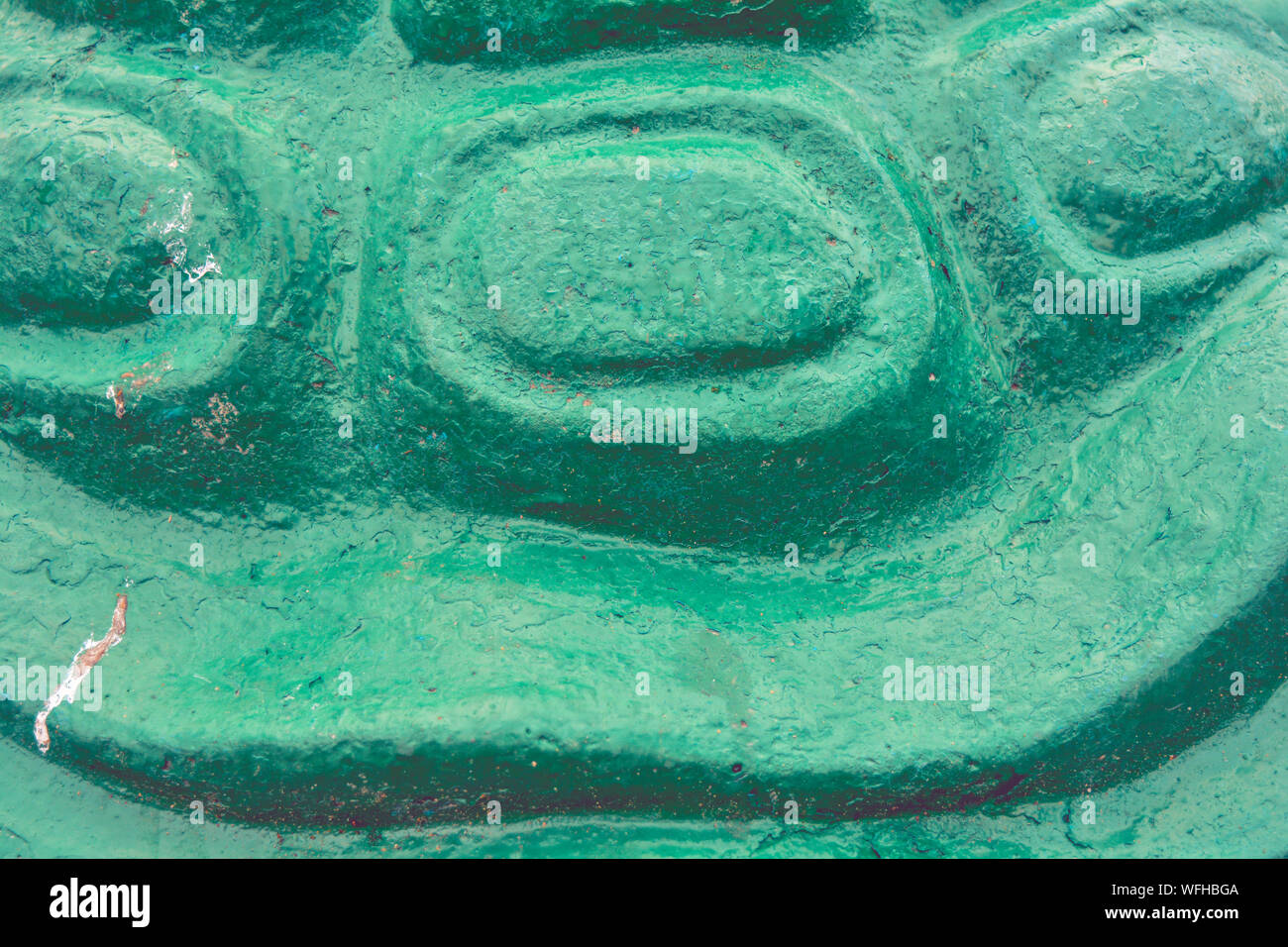 A fragment of imitation of concrete shell of turtle with green paint ...