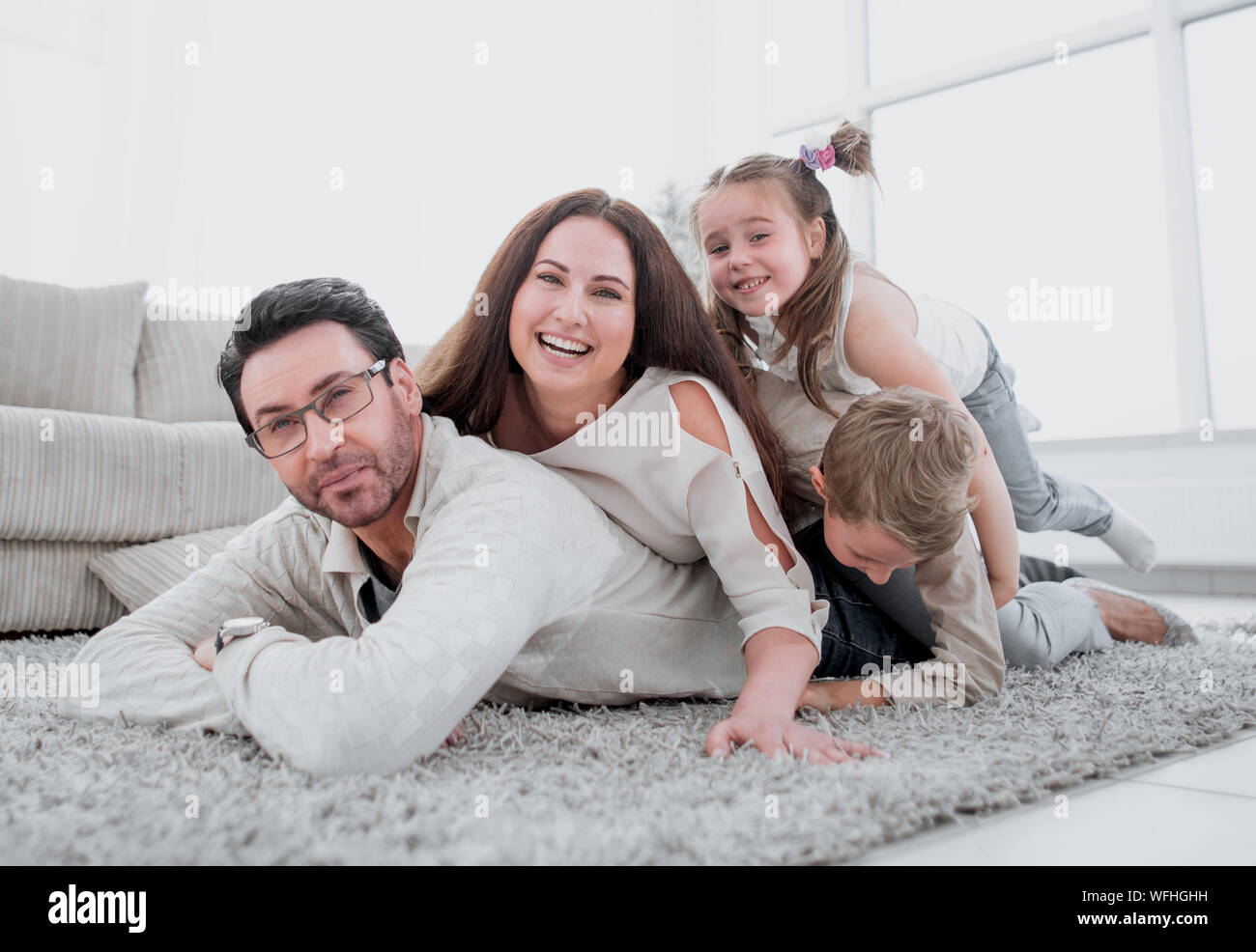 Happy family at home spending time togethe Stock Photo - Alamy