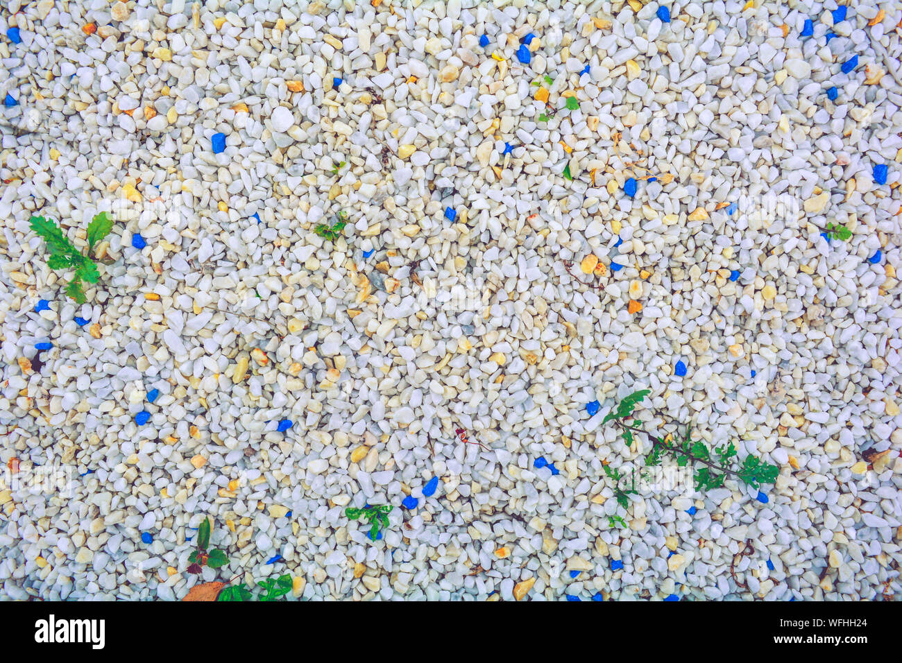 Gravel texture of white, yellow, blue small natural stone rubble with ...