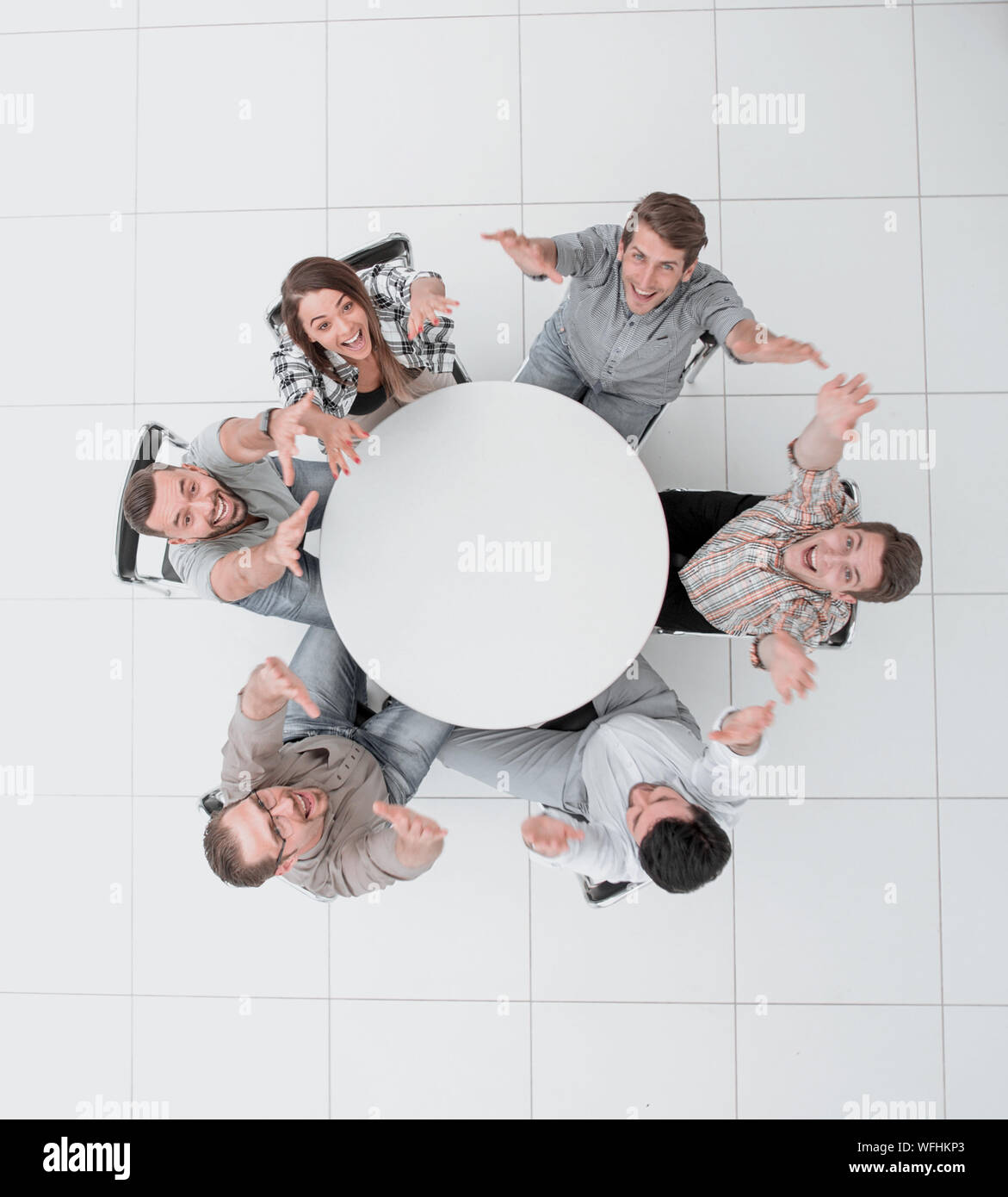 top view. business team holding up their hands and looking at the ...