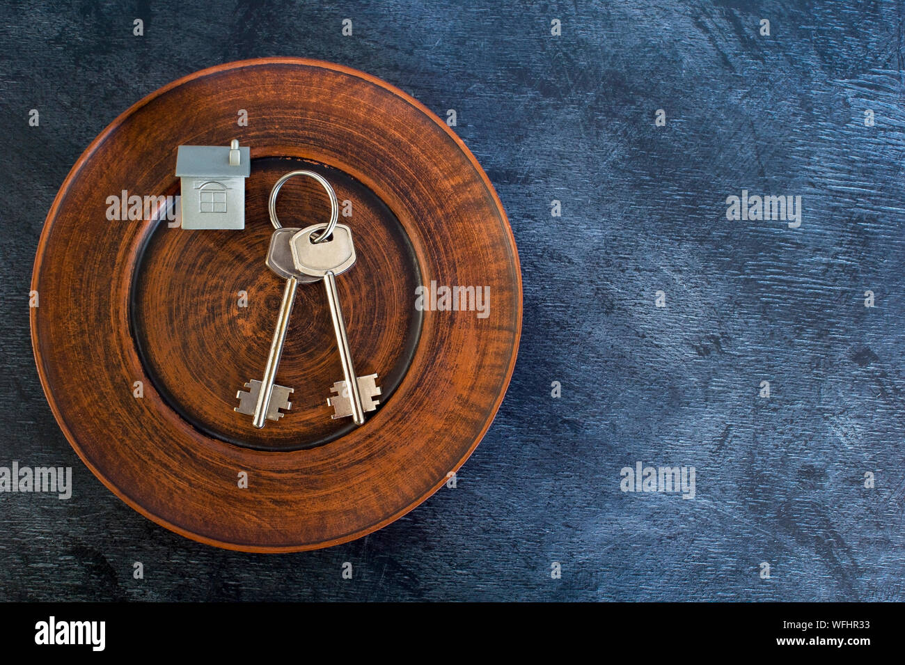 A bunch of keys lie on a vintage plate, along with an imitation of the ...
