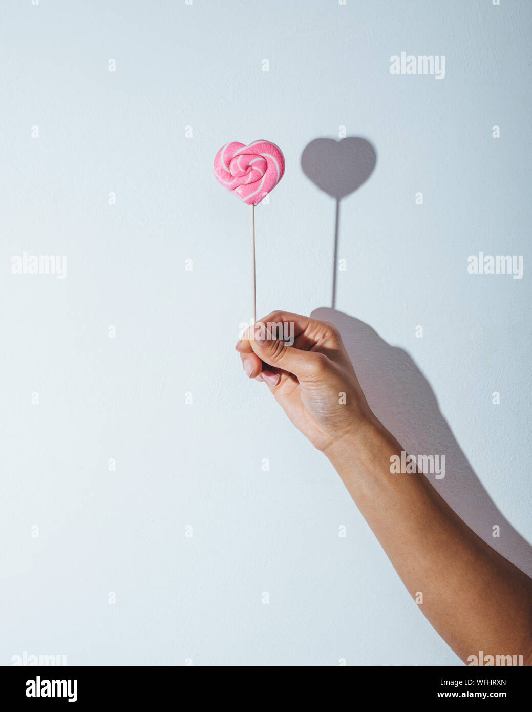 Hand holding lollipop hi-res stock photography and images - Alamy