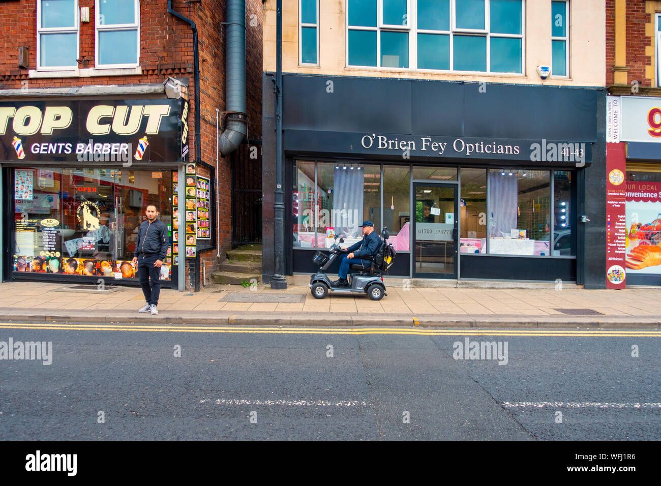 Rotherham town centre opticians and Gent Barber on a high street Stock ...