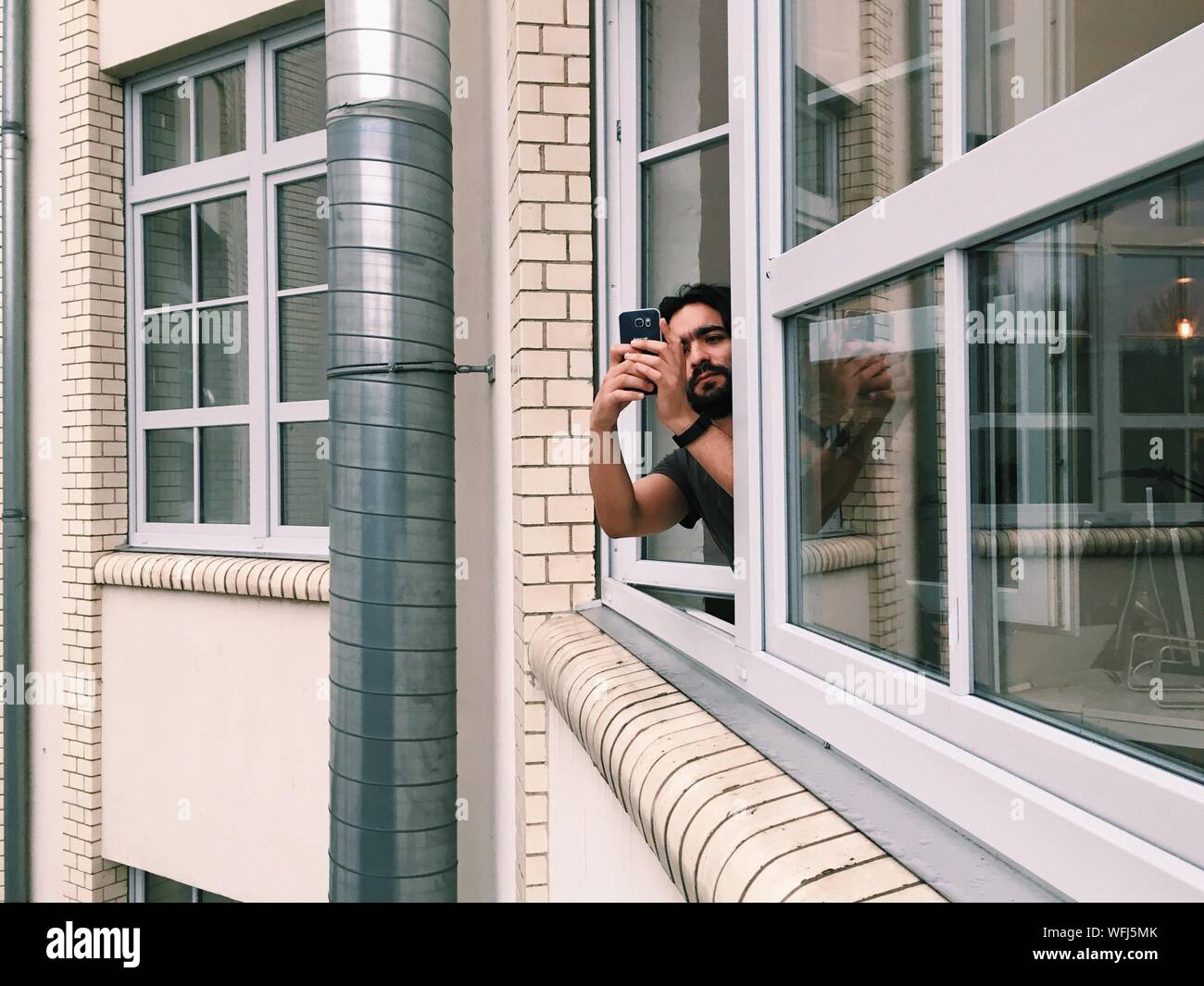 Man Photographing From Window Stock Photo - Alamy