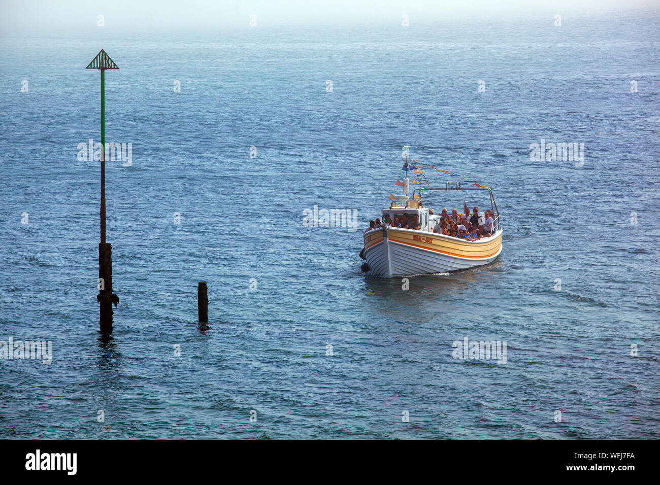 People tourists and holidaymakers on a boat trip around the bay in the ...