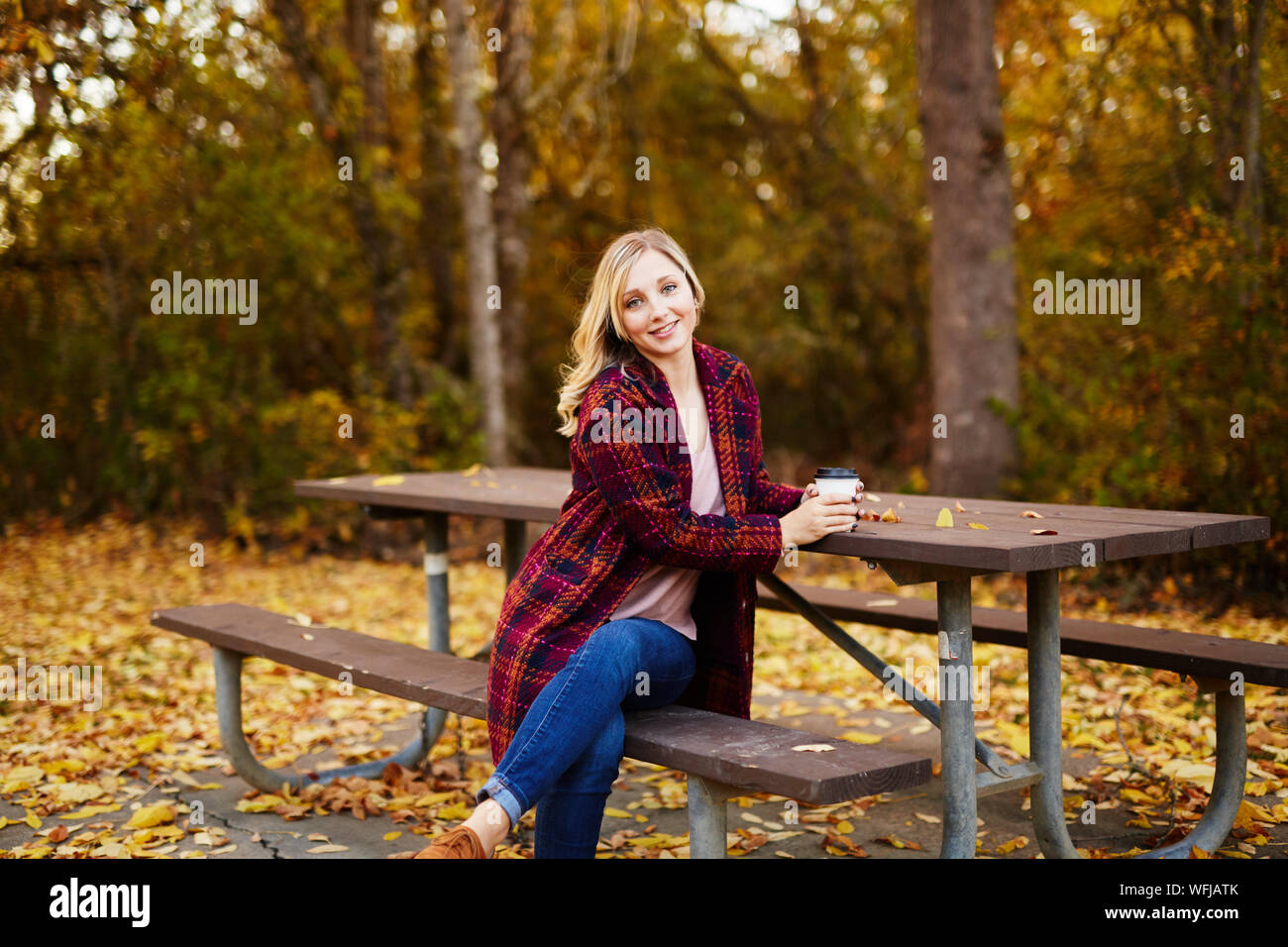 Young man sitting picnic table hi-res stock photography and images - Alamy