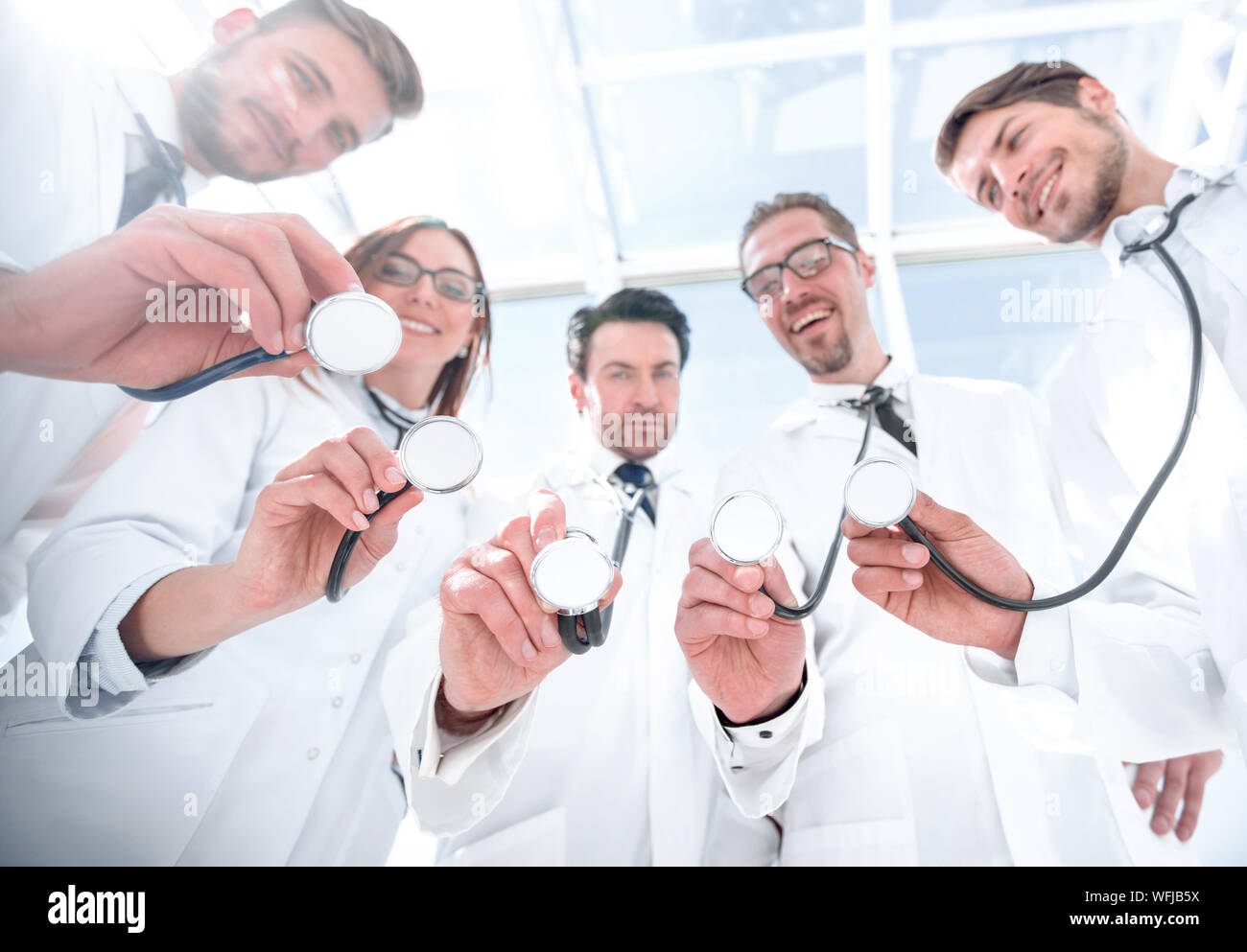 bottom view.a group of doctors have put their stethoscopes together ...