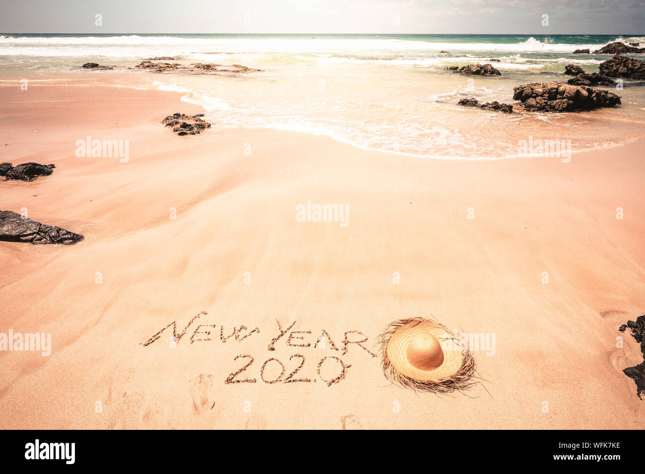 New year eve 2020 wrote on the sand at the beach in tropical paradise ...